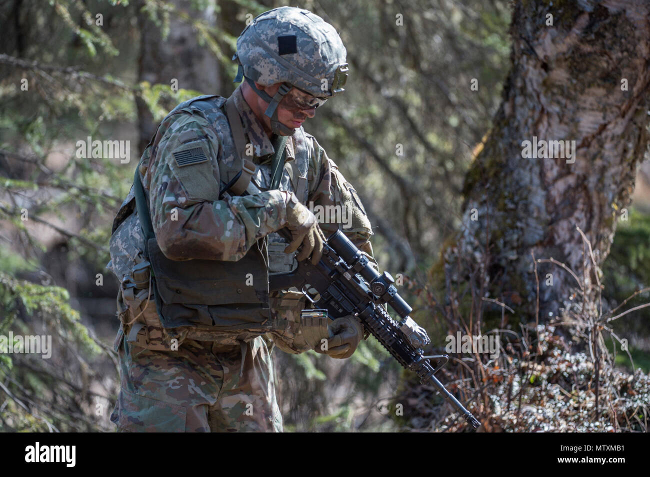 A paratrooper assigned to Scout Platoon, Headquarters and Headquarters ...