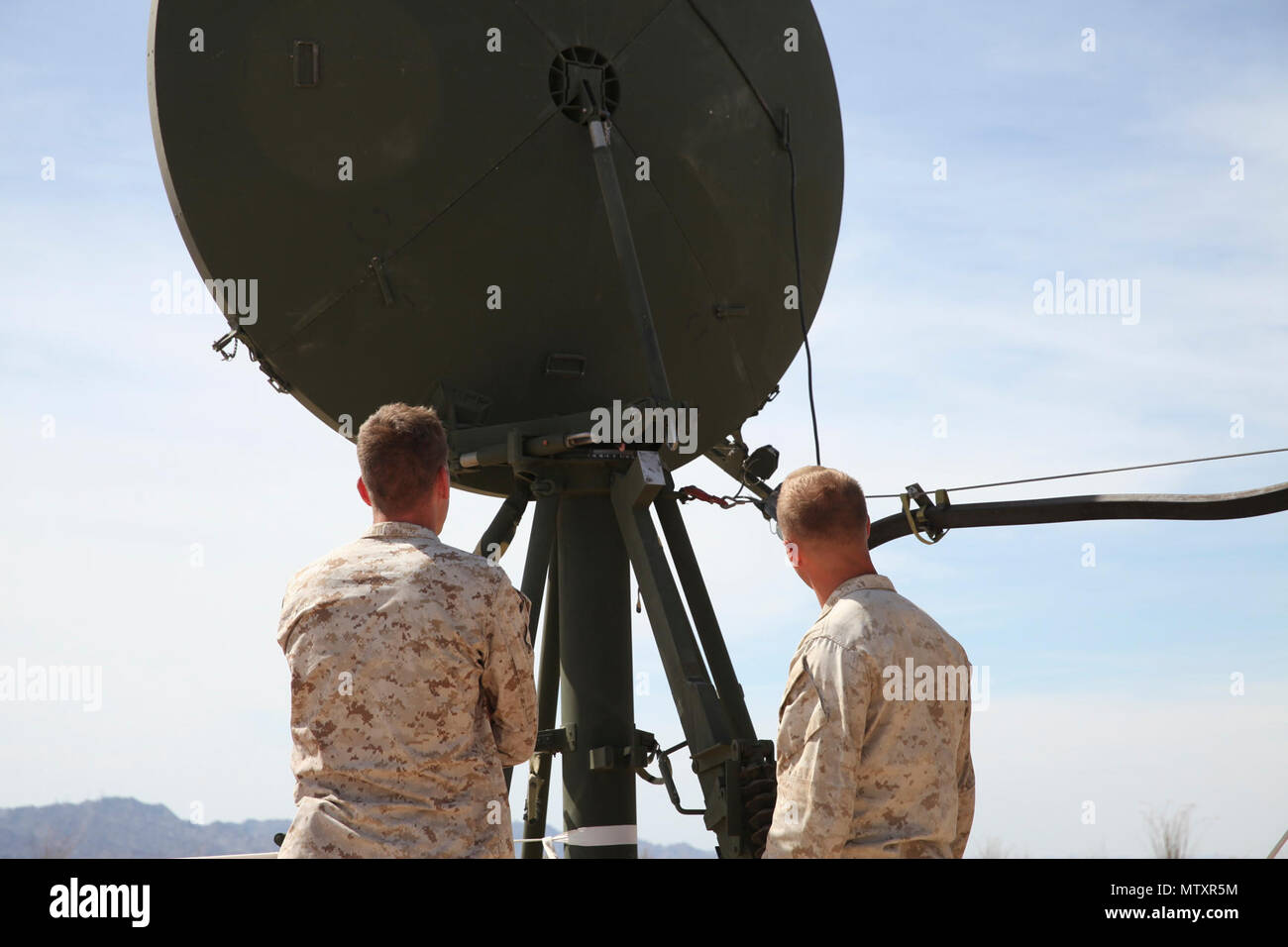 Matthew George, left, and Cpl. Austin Hardin inspect the dish of the ...