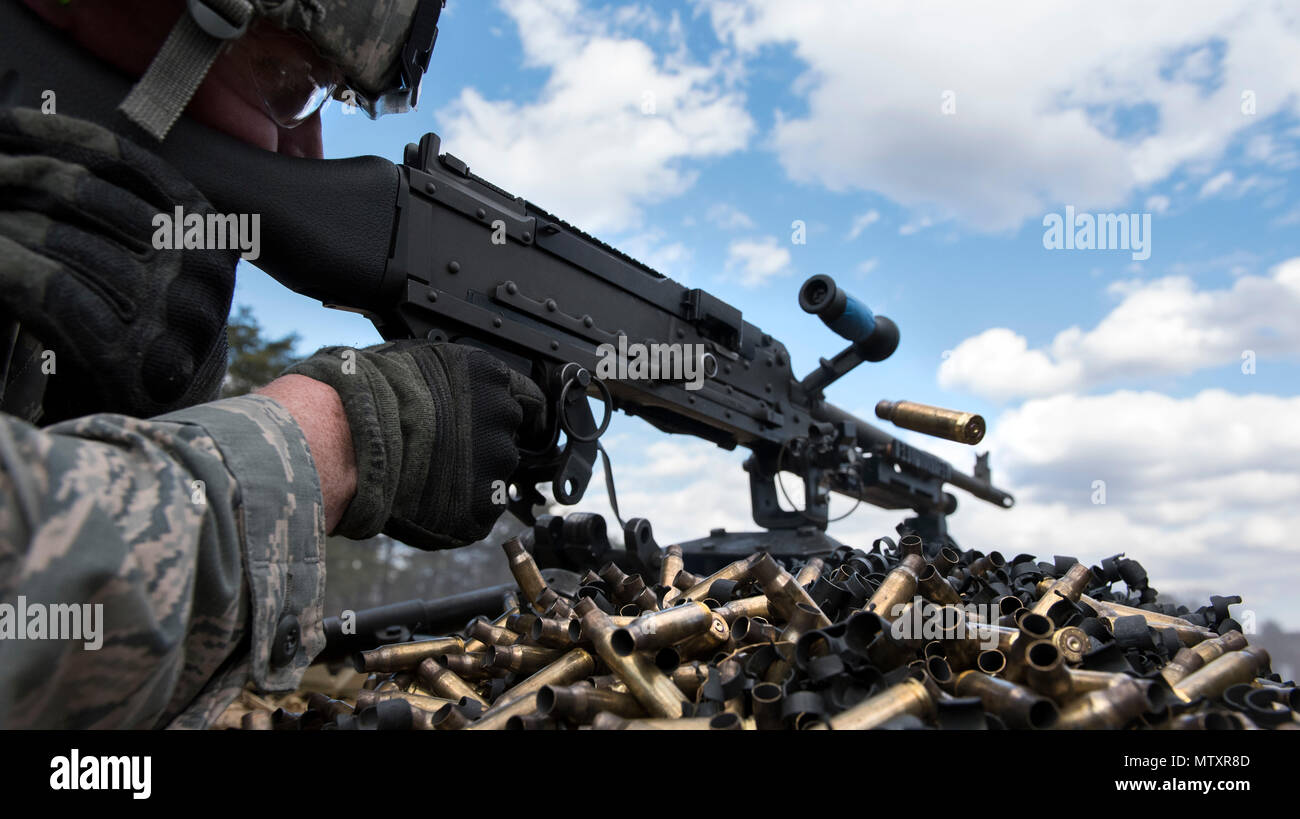 An 11th Security Forces Squadron members shoots a M240B machine guns ...