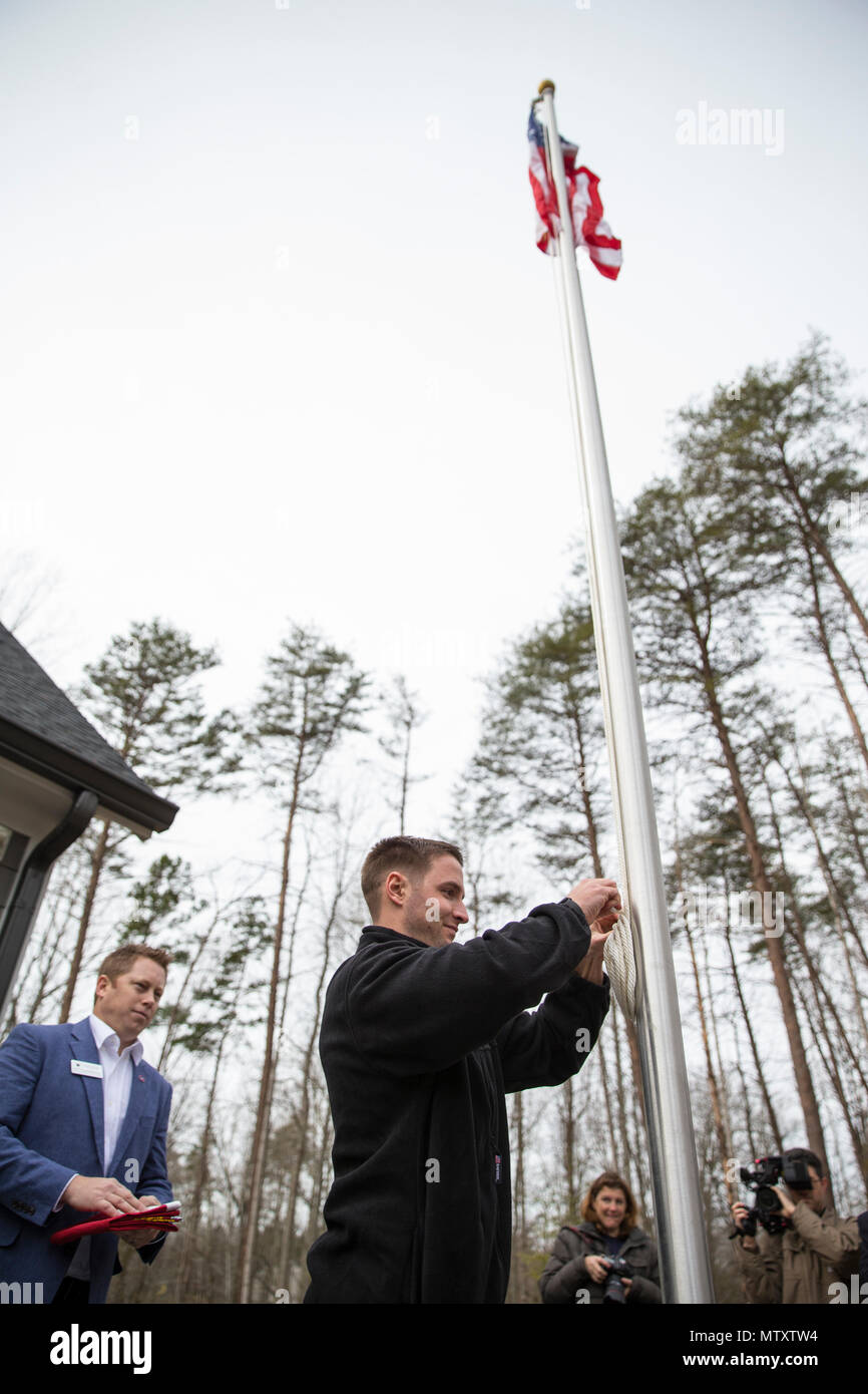 Retired U.S. Marine Corps Cpl. Garrett Jones raises an American flag on ...