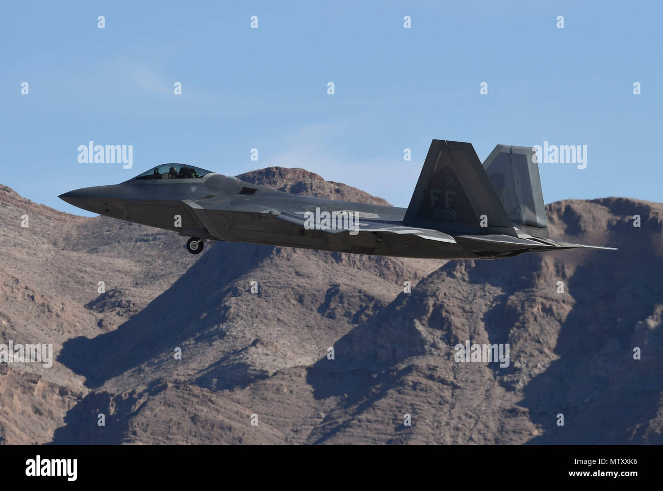 An F-22 Raptor flies over Nellis Air Force Base, Nev., during Red Flag ...