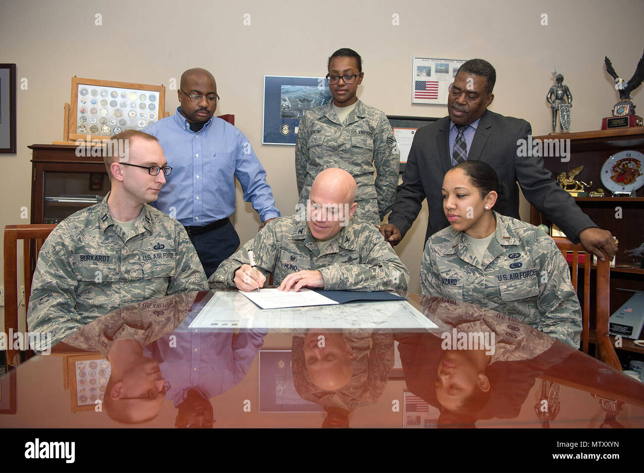 Col. Roman L. Hund, installation commander, signs an African American ...