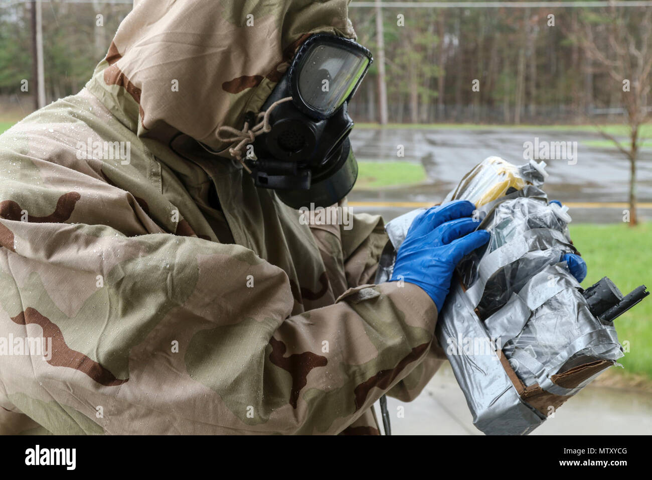 A 10th Mountain Division Soldier looks at some of the hand-held ...
