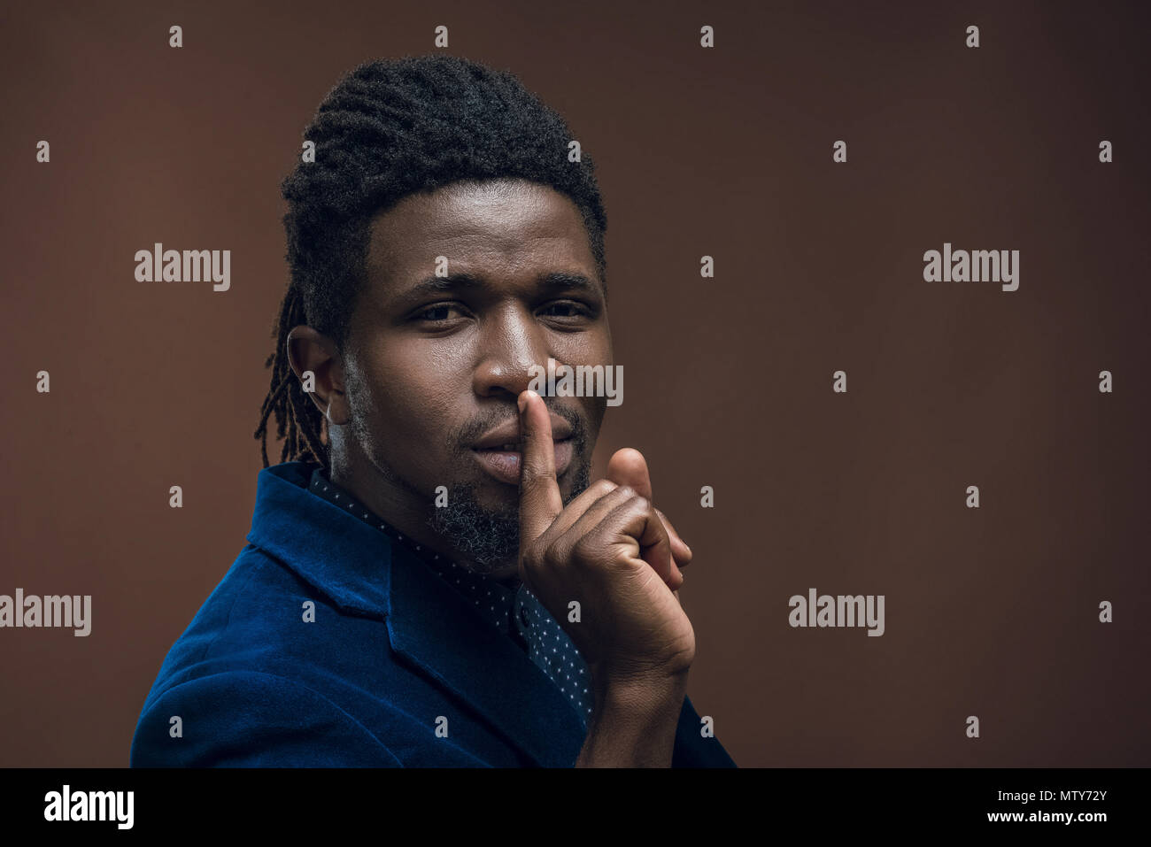 Black man showing silence gesture hi-res stock photography and images ...