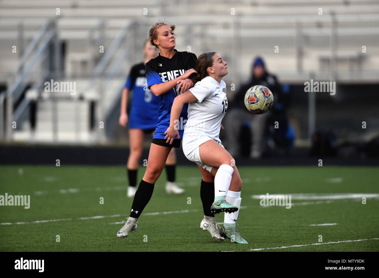 Forward playing a ball off her body while shielding an opponent on ...