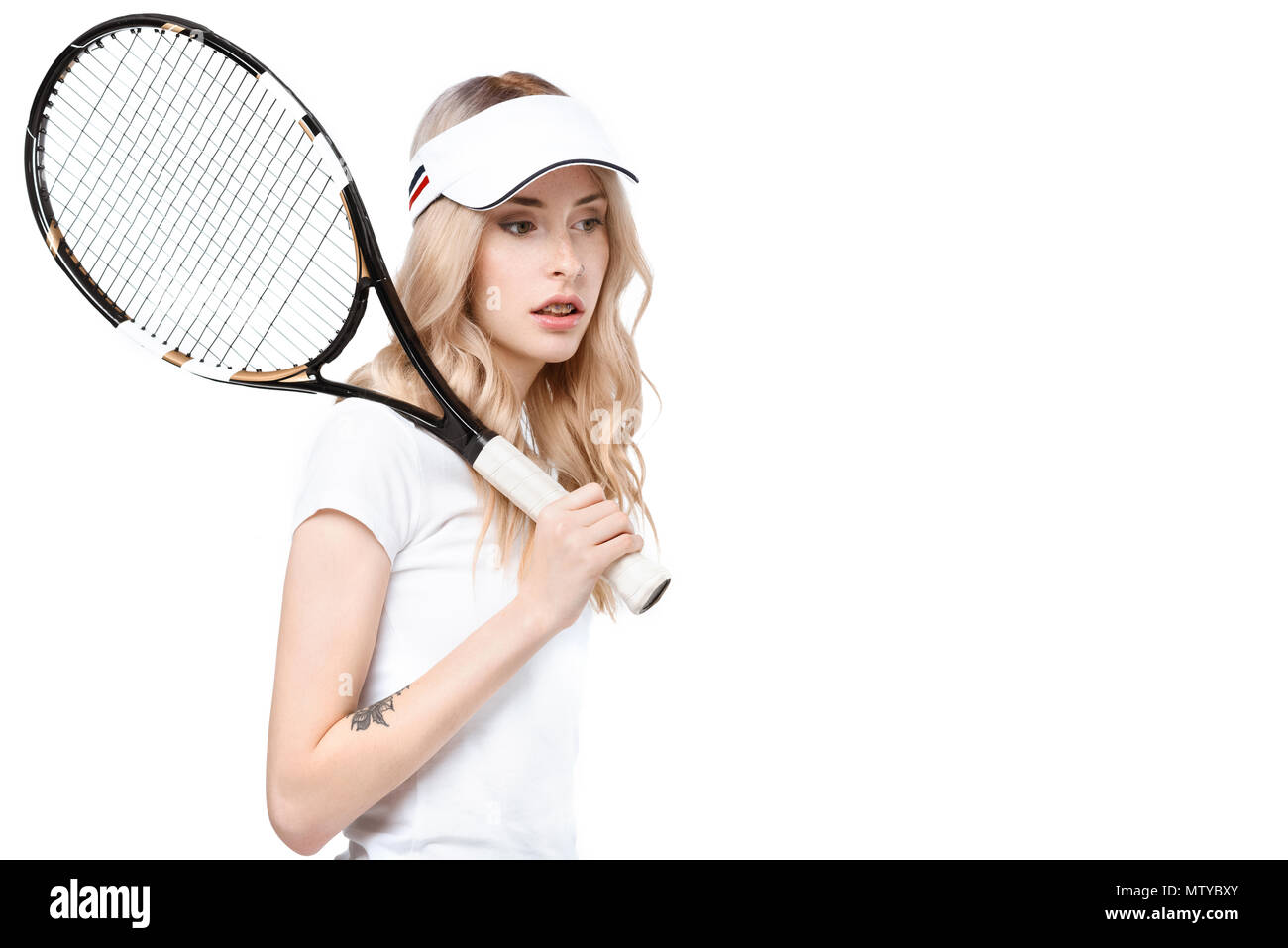 Half-length shot of a young woman with a tennis racket Stock Photo - Alamy