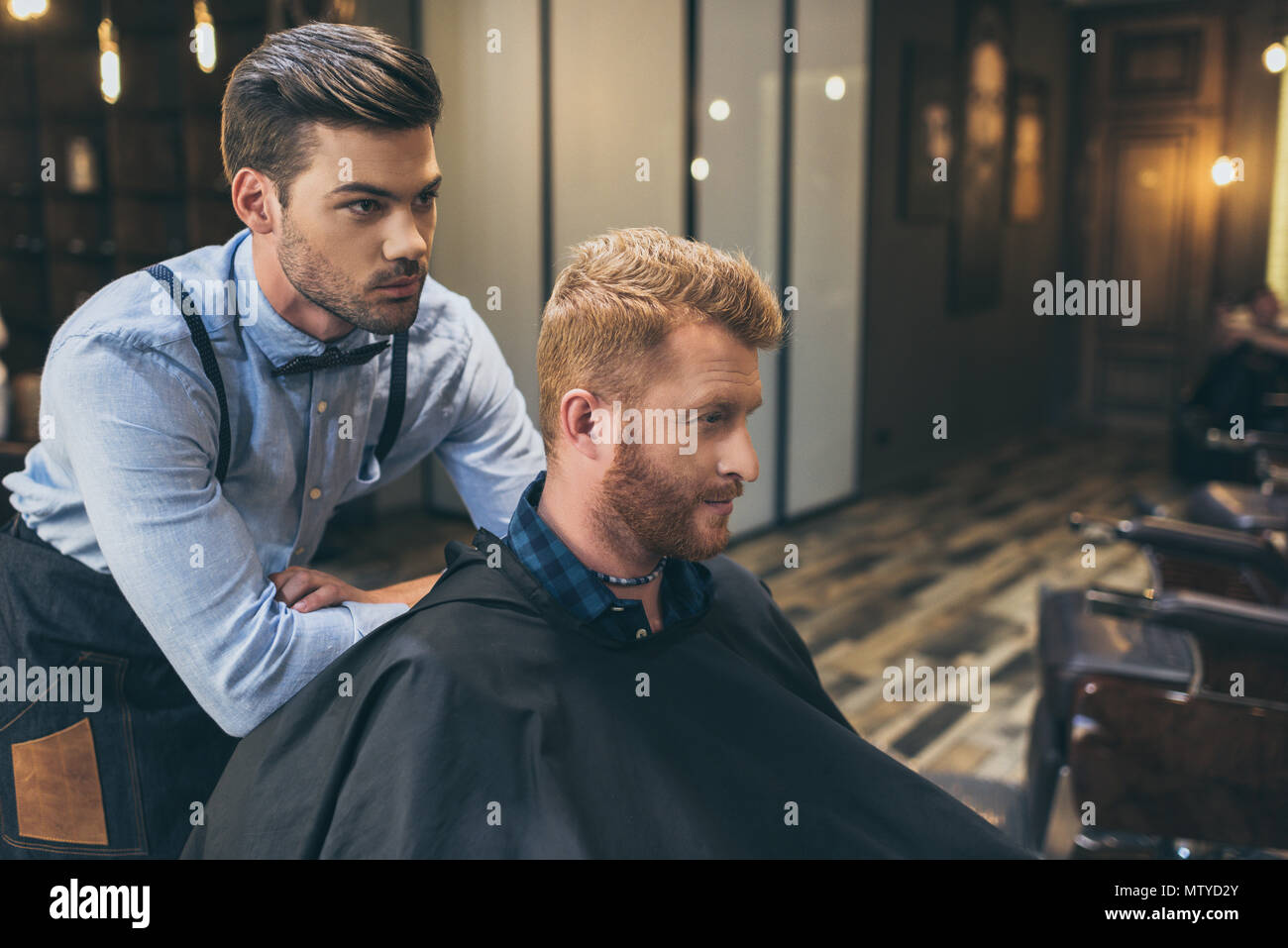 Man standing behind chair hi-res stock photography and images - Alamy