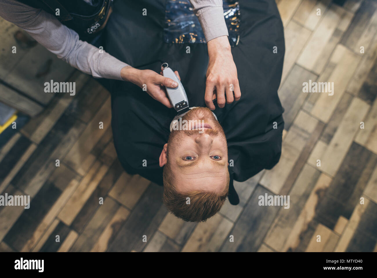 Male barber trimming customers beard in barber shop Stock Photo - Alamy
