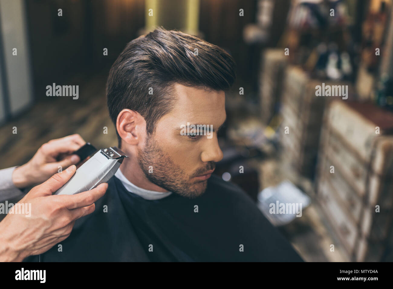 Male barber cutting hair of customer in barber shop Stock Photo - Alamy