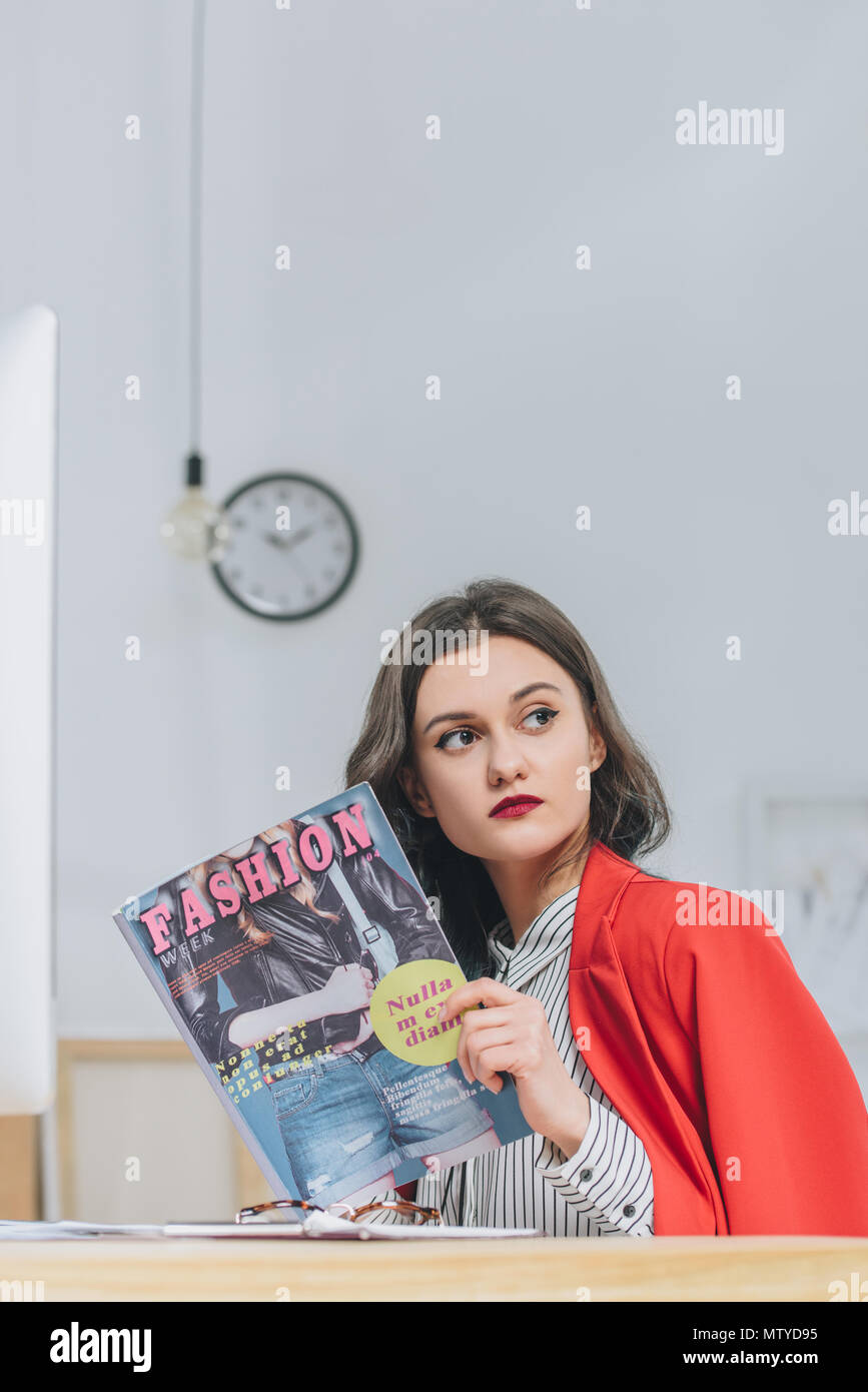 Pretty lady reading fashion magazine Stock Photo - Alamy