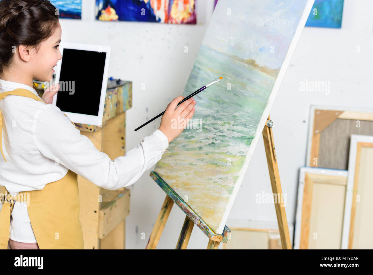 Female artist using brush painting hi-res stock photography and images ...