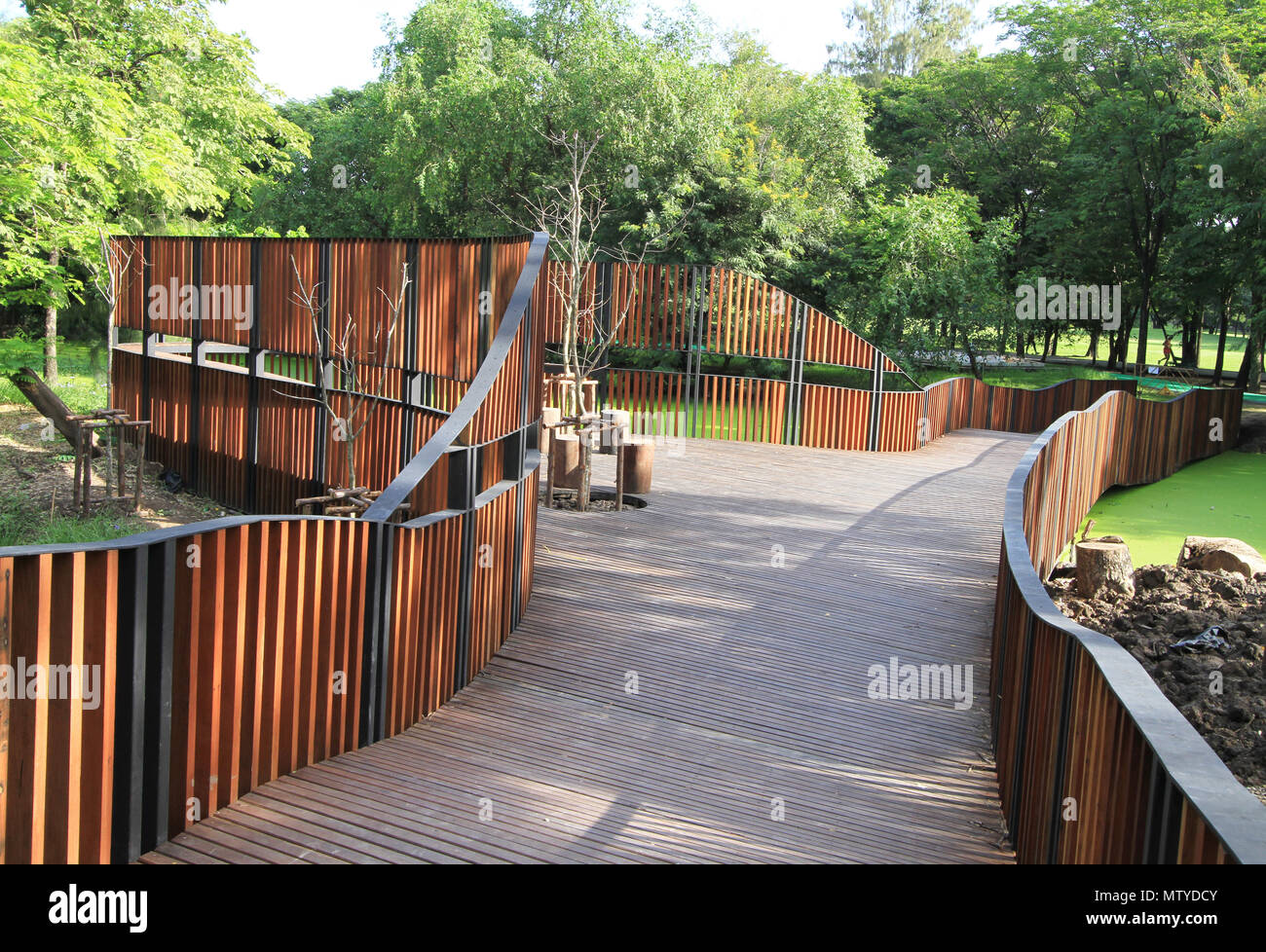 Wooden walkway with handrail in the park Stock Photo - Alamy