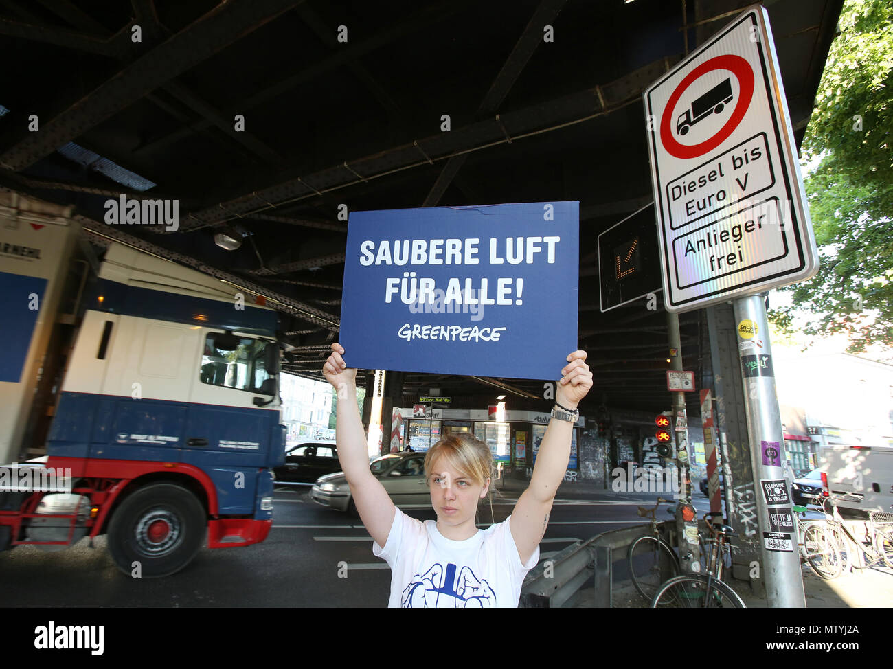 31 May 2018, Germany, Hamburg: A Greenpeace activist holding a sign ...