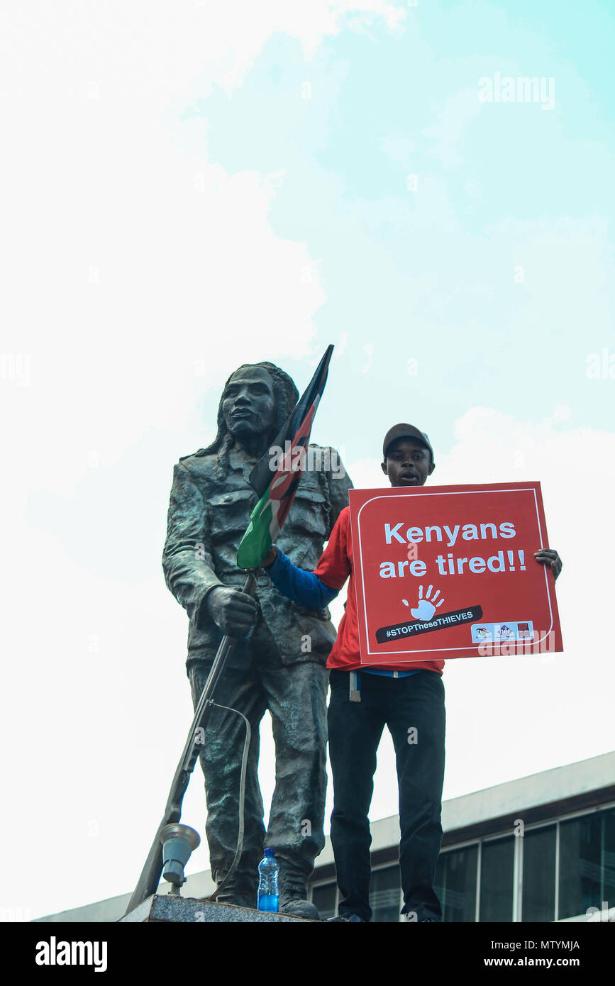 Nairobi, Kenya. 31st May, 2018. A protestor carry placard standing next ...