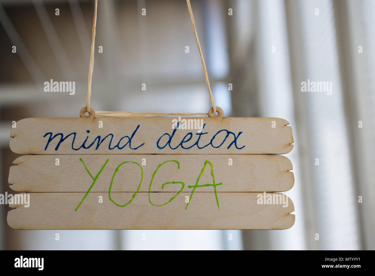 Mind Detox Yoga sign hanging from ceiling Stock Photo - Alamy