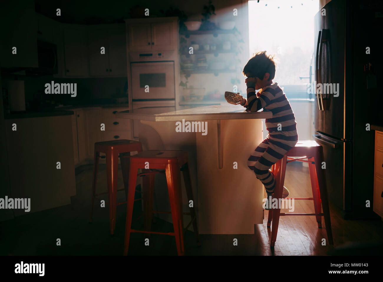 Children eating breakfast cereal hi-res stock photography and images ...