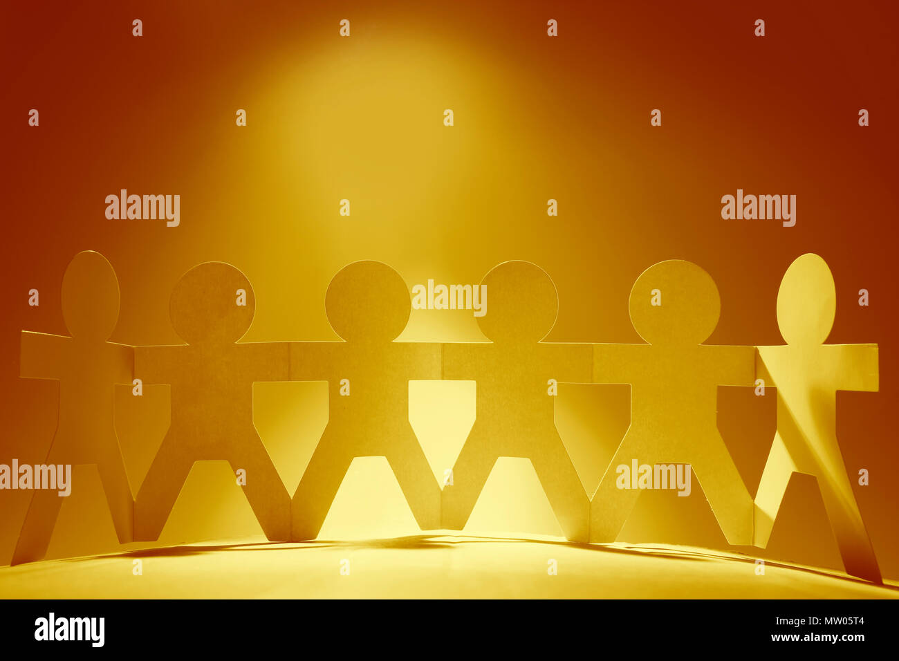 Team of paper chain people in a row holding hands Stock Photo - Alamy