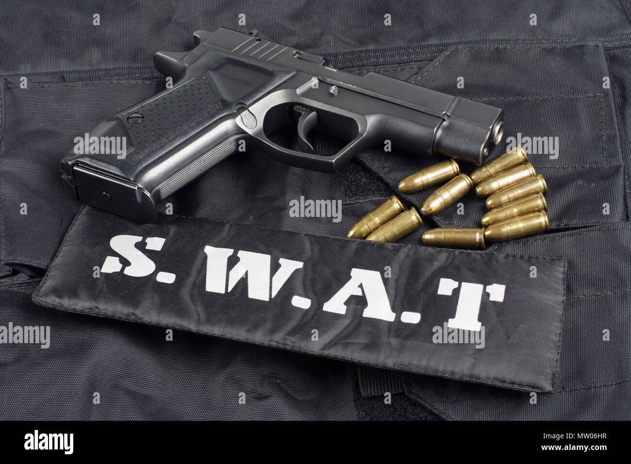 SWAT teams concept -handgun on black uniform background Stock Photo - Alamy