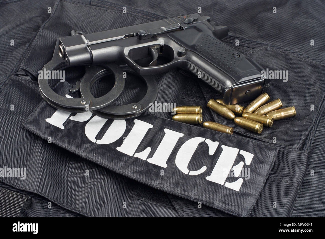 Police concept - handgun on black uniform background Stock Photo - Alamy