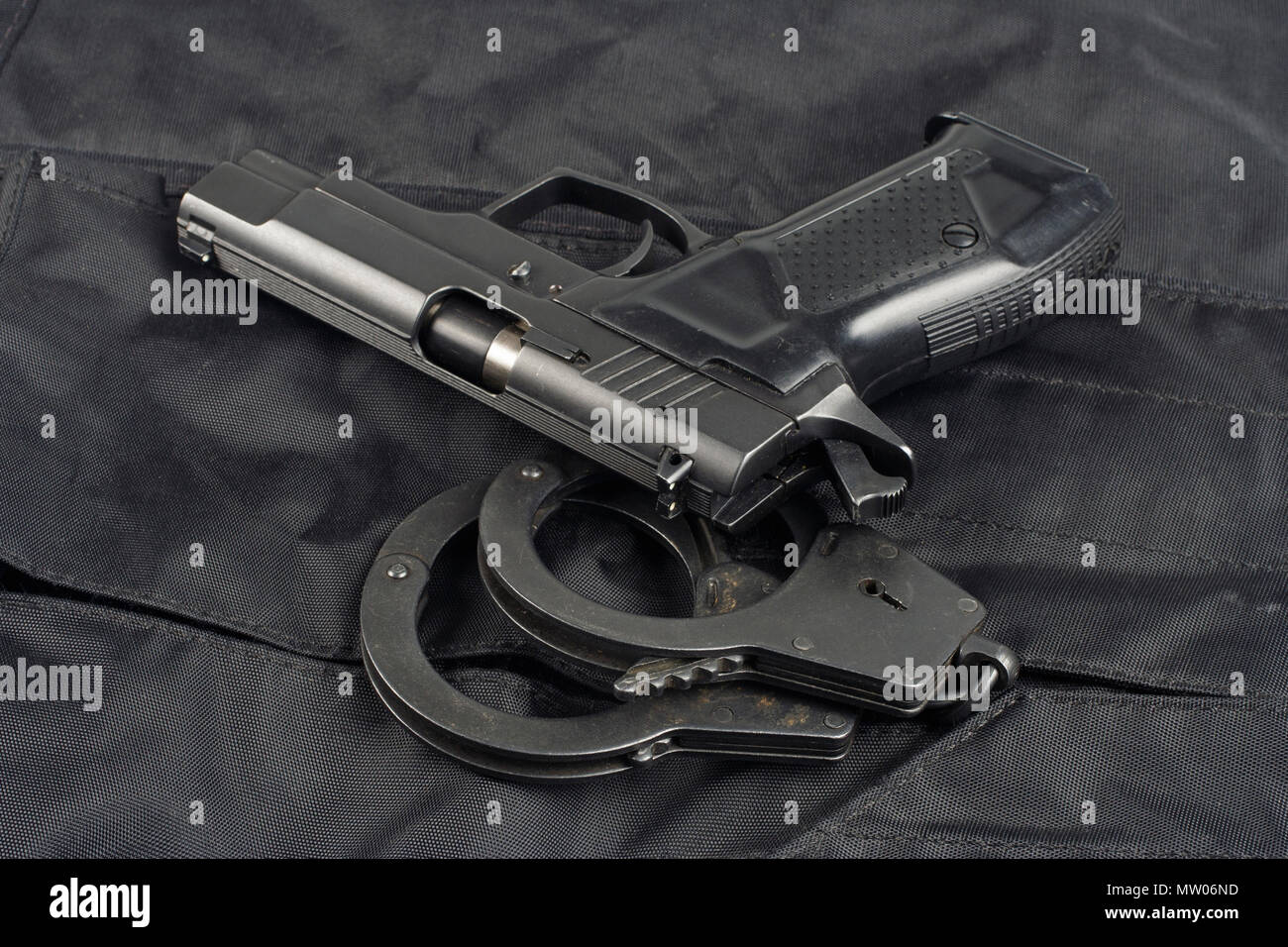 Police concept - handgun on black uniform background Stock Photo - Alamy