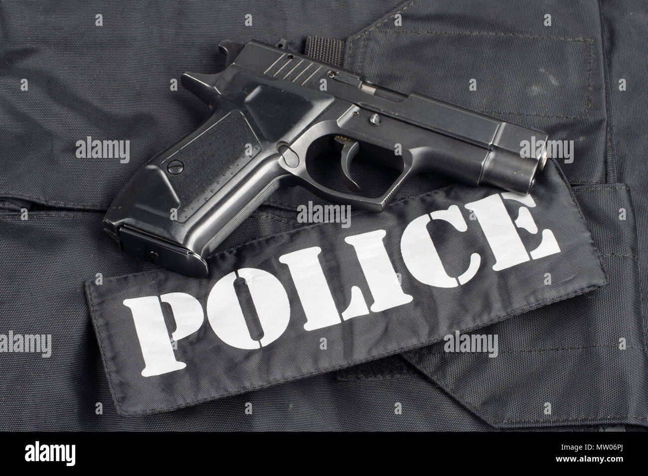 Police concept - handgun on black uniform background Stock Photo - Alamy