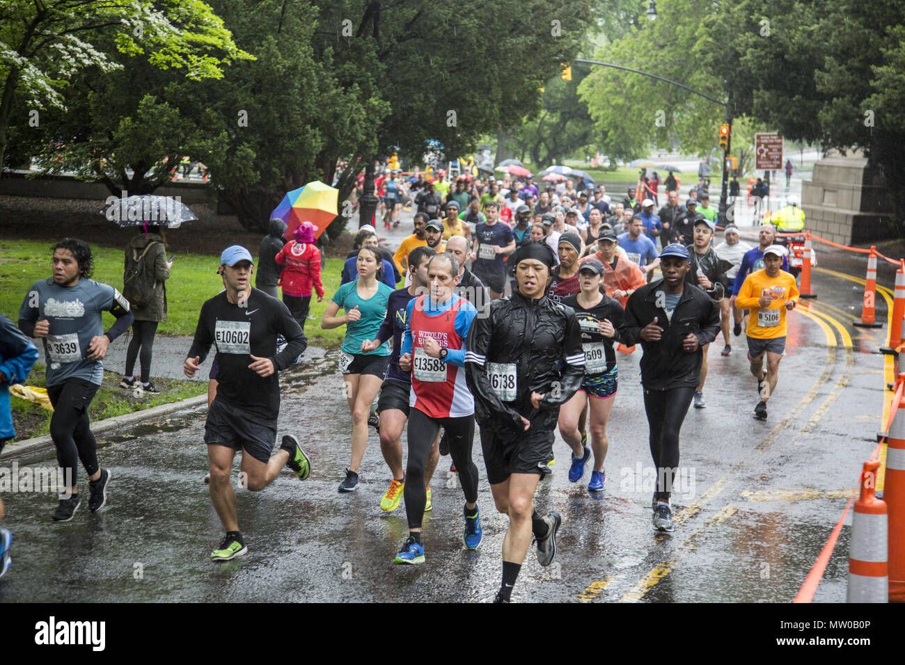 Runners race through the rain in Prospect Park during the first half of ...