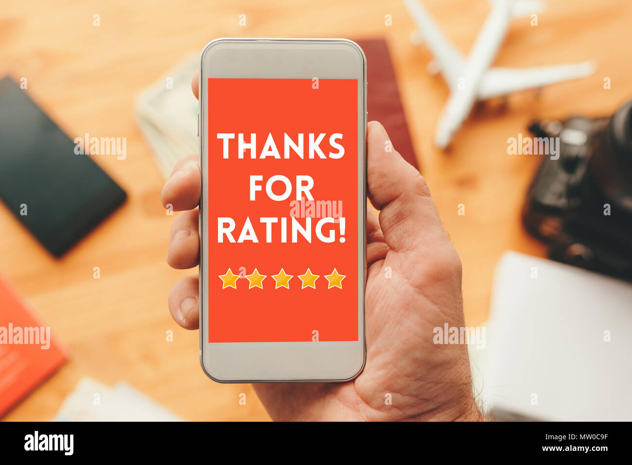 Thanks for rating message on smartphone screen in male hand. Customer ...