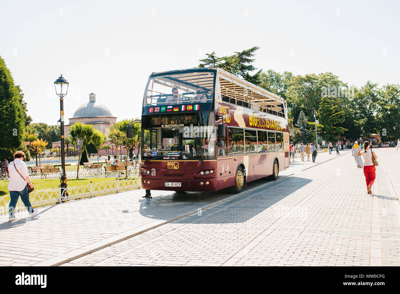 Editorial image of tourist sightseeing bus picking up passengers at the ...