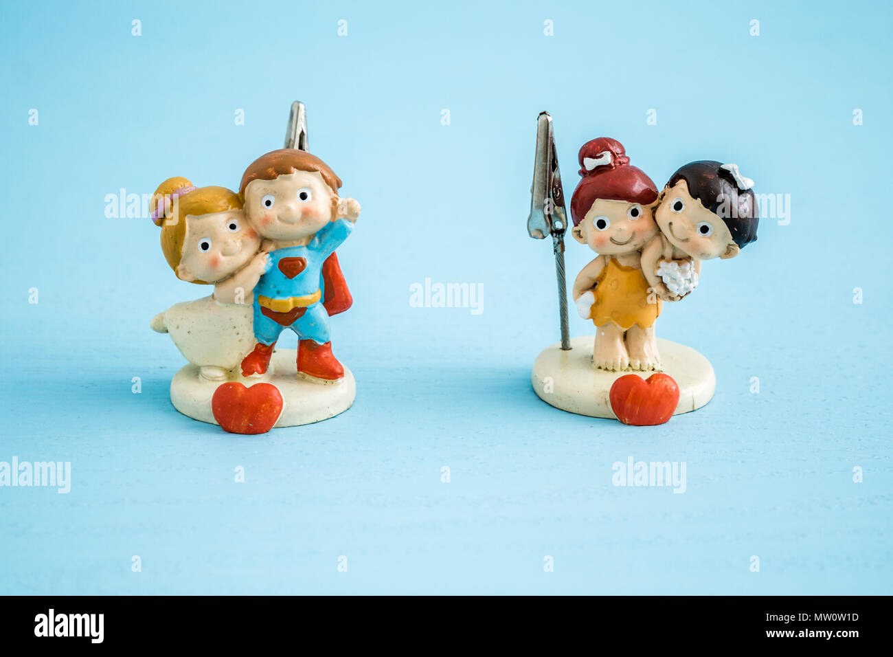 Cute children figure model trinket paperweight on blue Stock Photo - Alamy