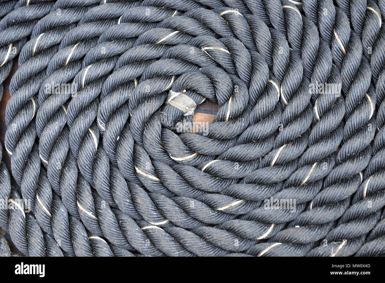 Thick rope wrapped in a spiral on the ship's deck Stock Photo - Alamy