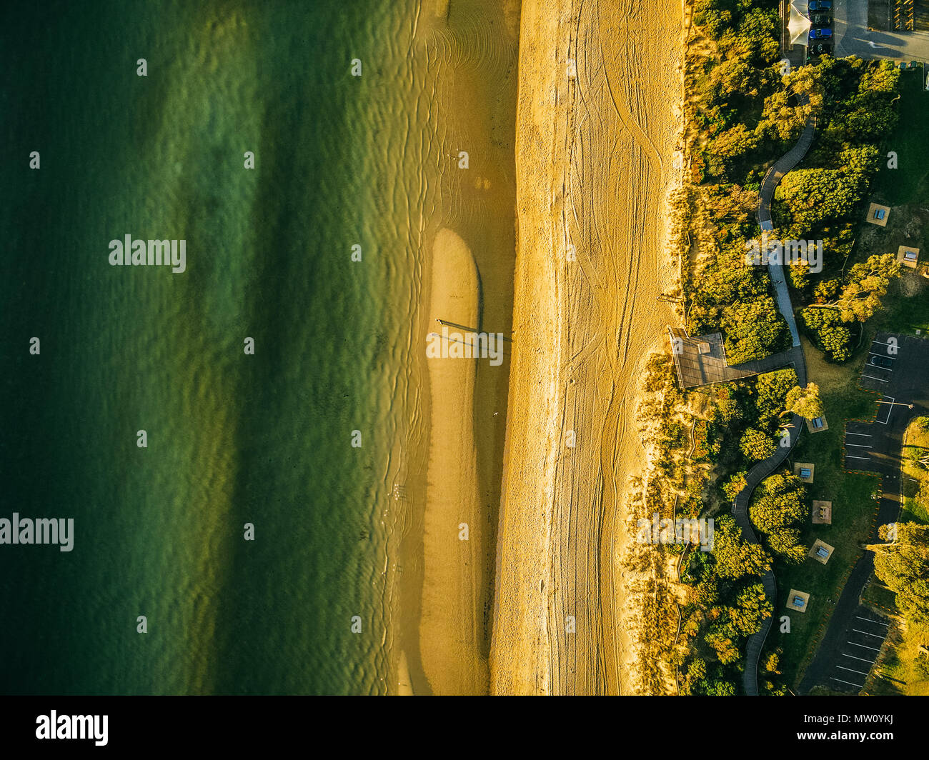 Aerial view of ocean beach at sunset - looking straight down at water ...