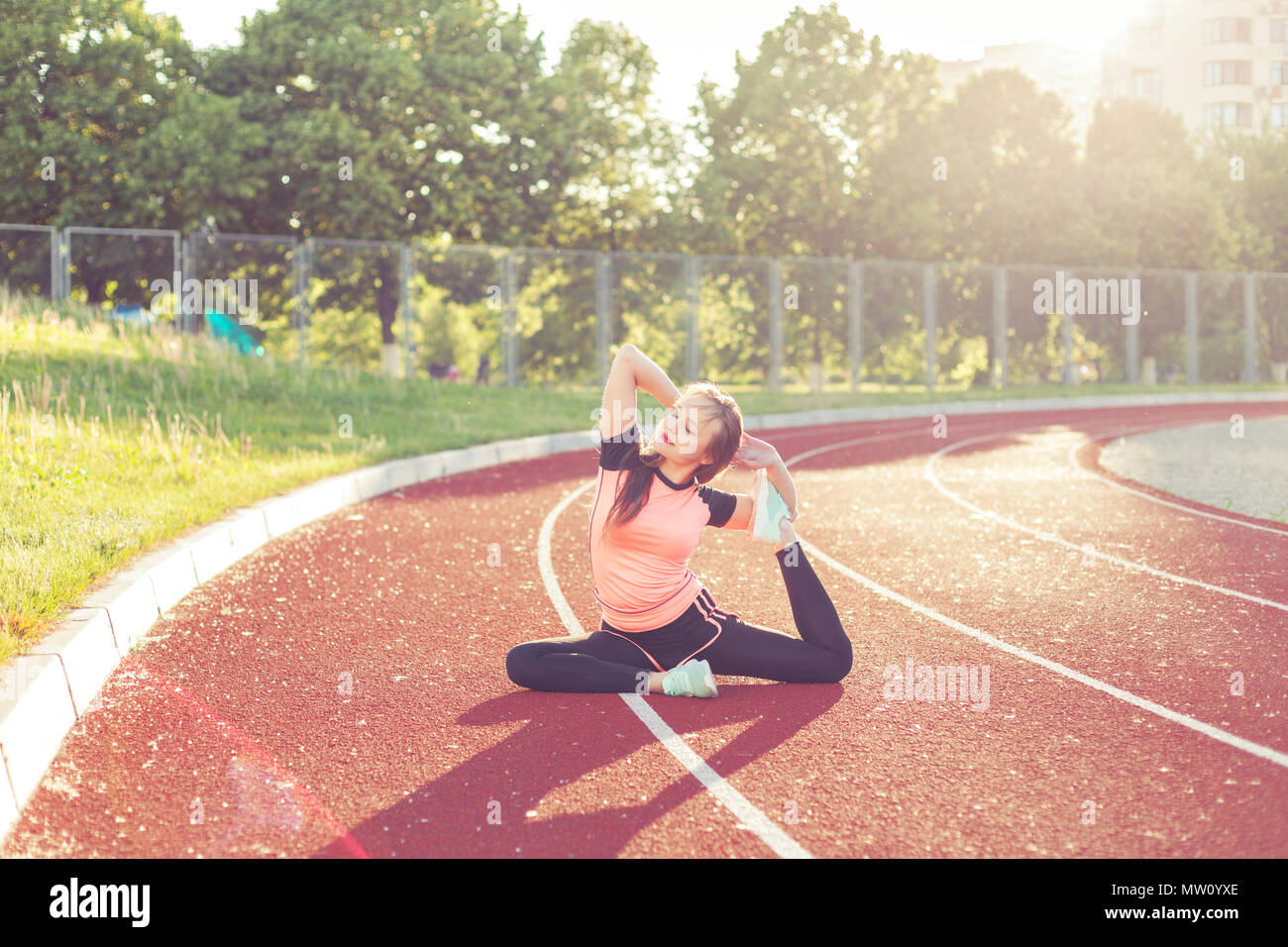 Woman doing gymnastics warm-up before competitions at the stadium Stock ...