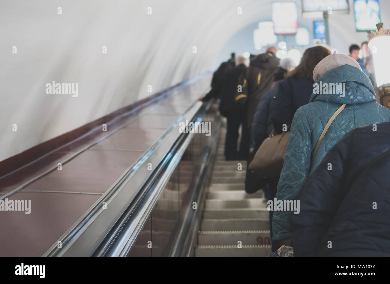 People riding the escalator in metro station Stock Photo - Alamy