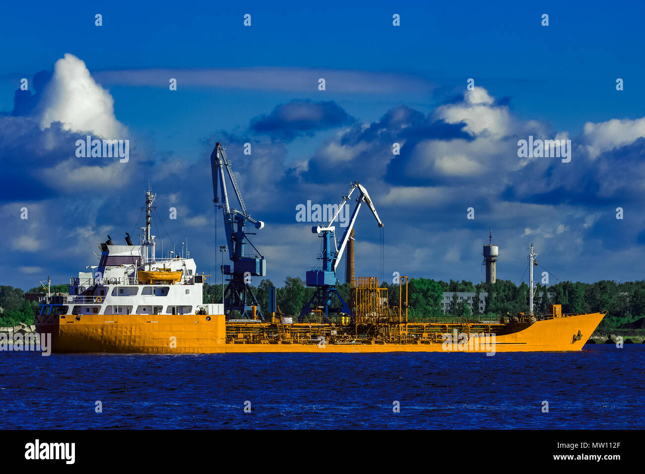 Yellow cargo tanker ship moving at the clear summer day Stock Photo - Alamy