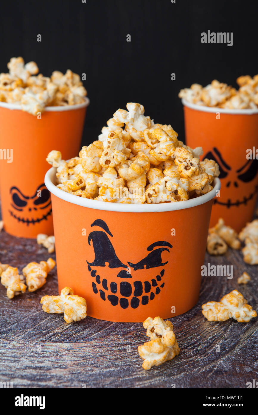 Salty Popcorn for Halloween with scary pumpkin faces Stock Photo - Alamy