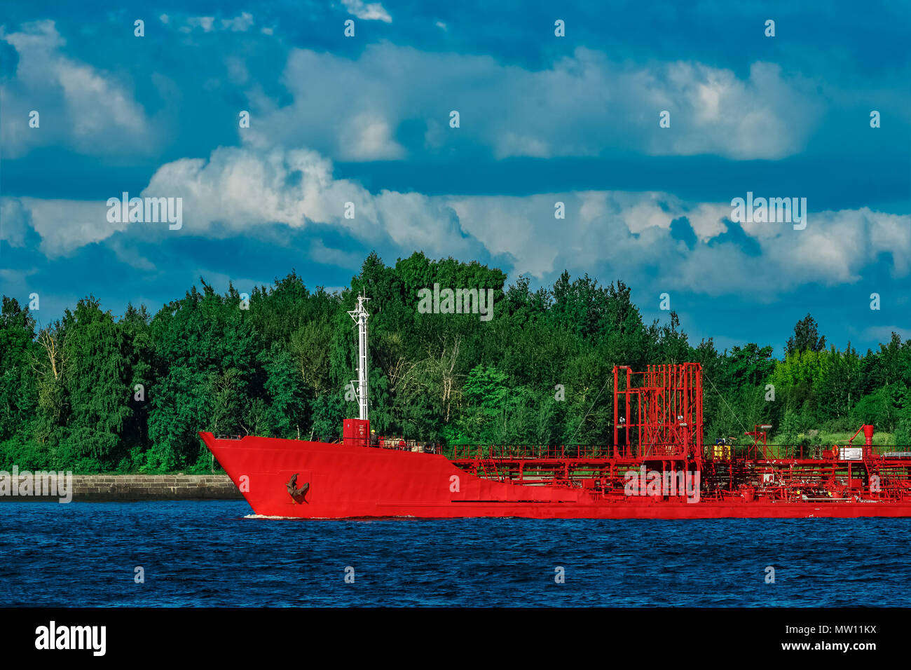 Red cargo tanker ship moving by the river Stock Photo - Alamy