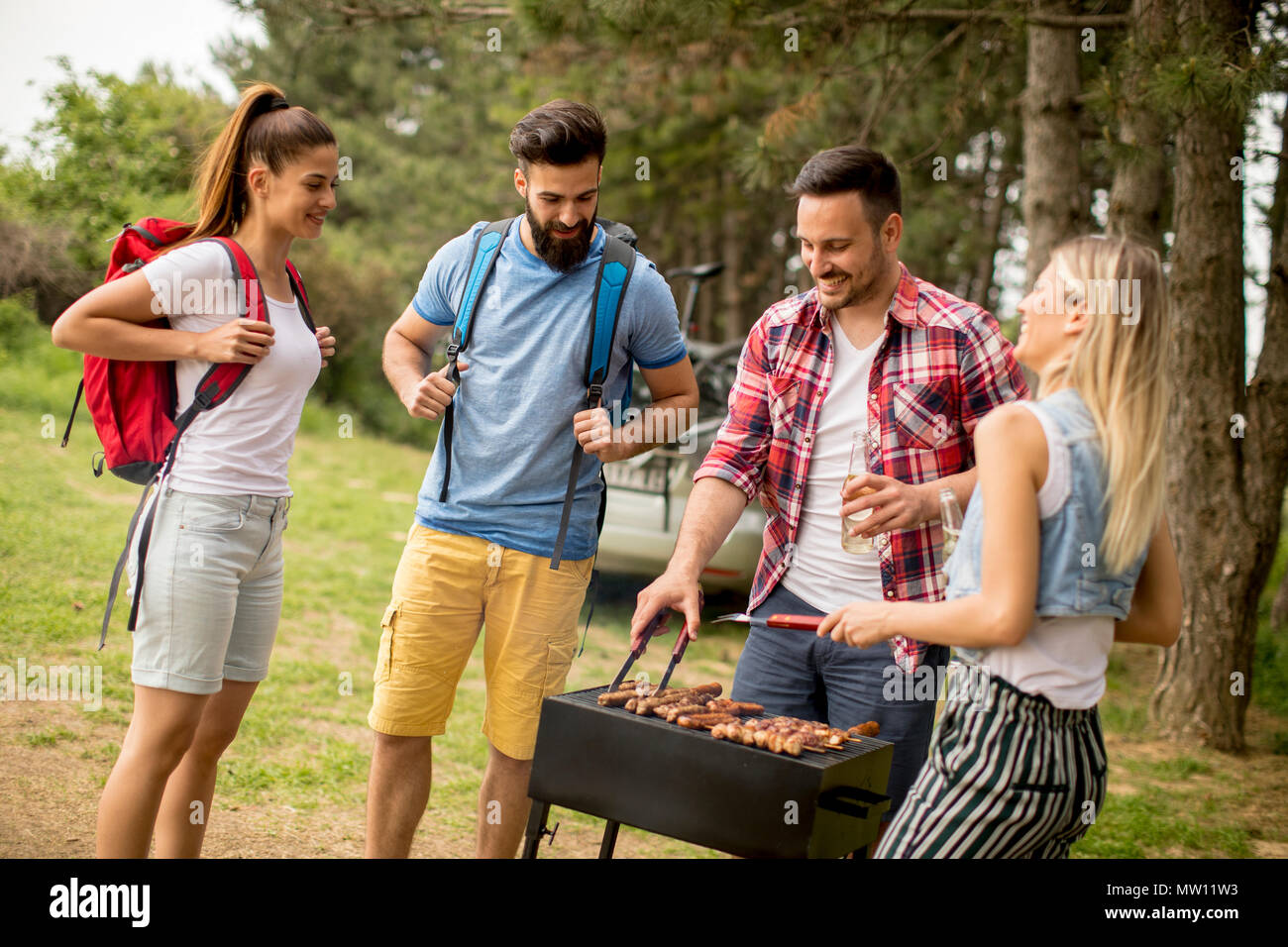 Group of young people enjoying barbecue party in the nature Stock Photo ...