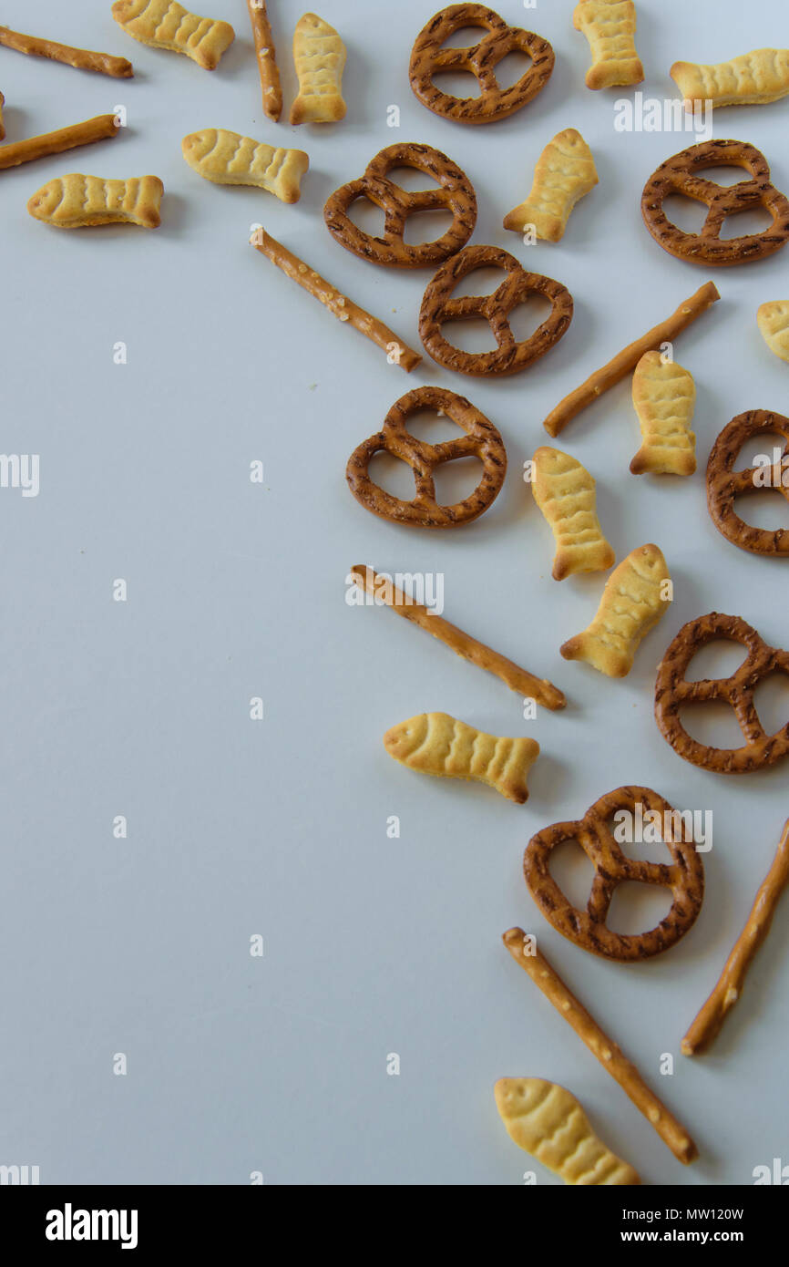 Salty snacks/crisps on white background, space for text Stock Photo - Alamy