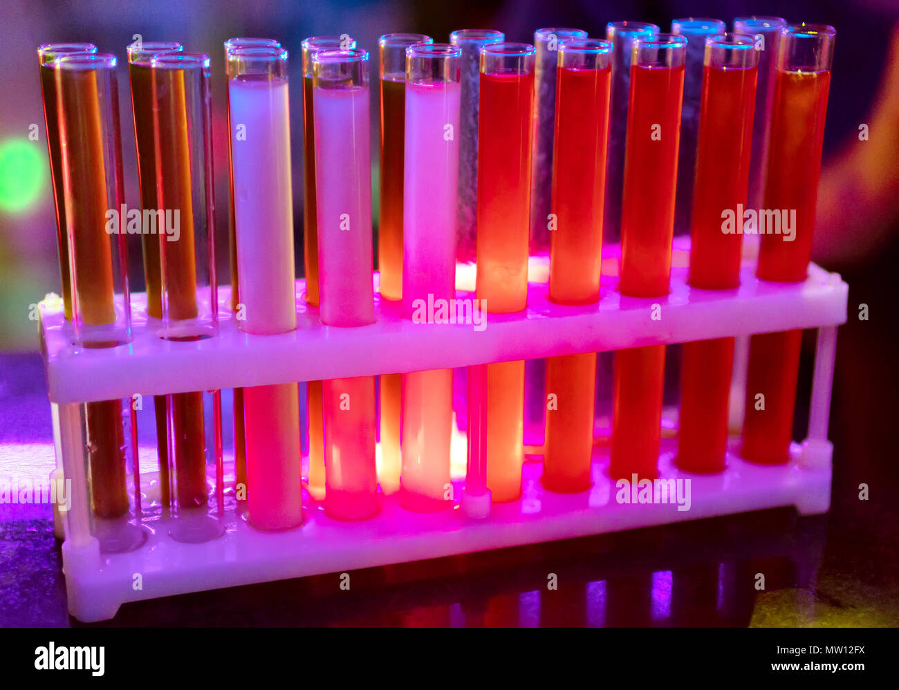 Twenty alcohol cocktails in test tubes in concept bar Stock Photo - Alamy