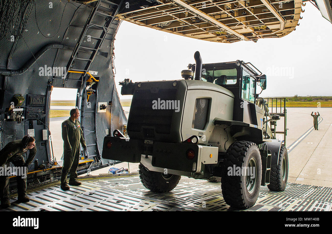 Airmen from the 433rd Airlift Wing unload a 10K all-terrain vehicle ...
