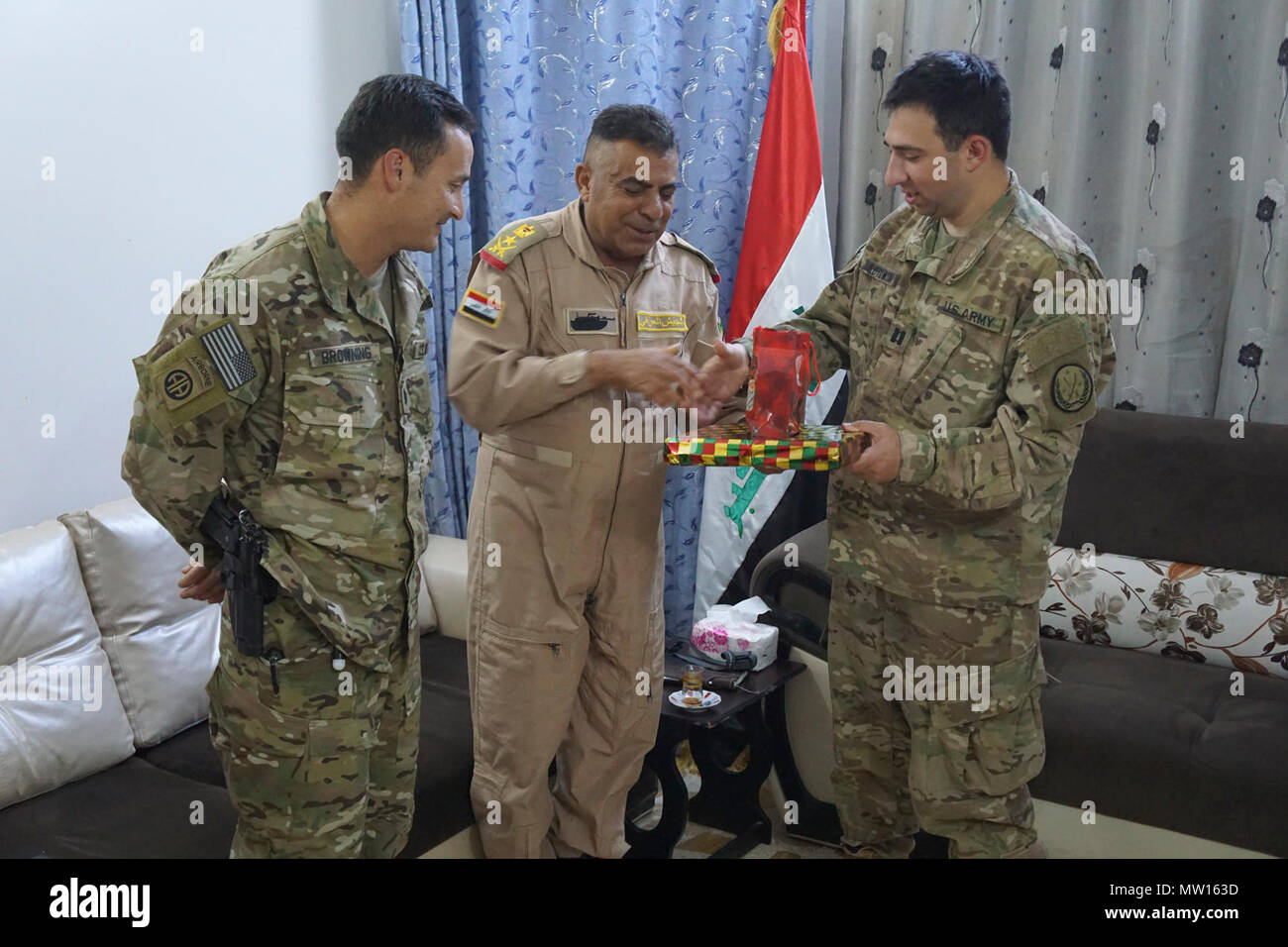 U.S. Army Capt. Matt Kotowski (right) receives a present from the 9th ...