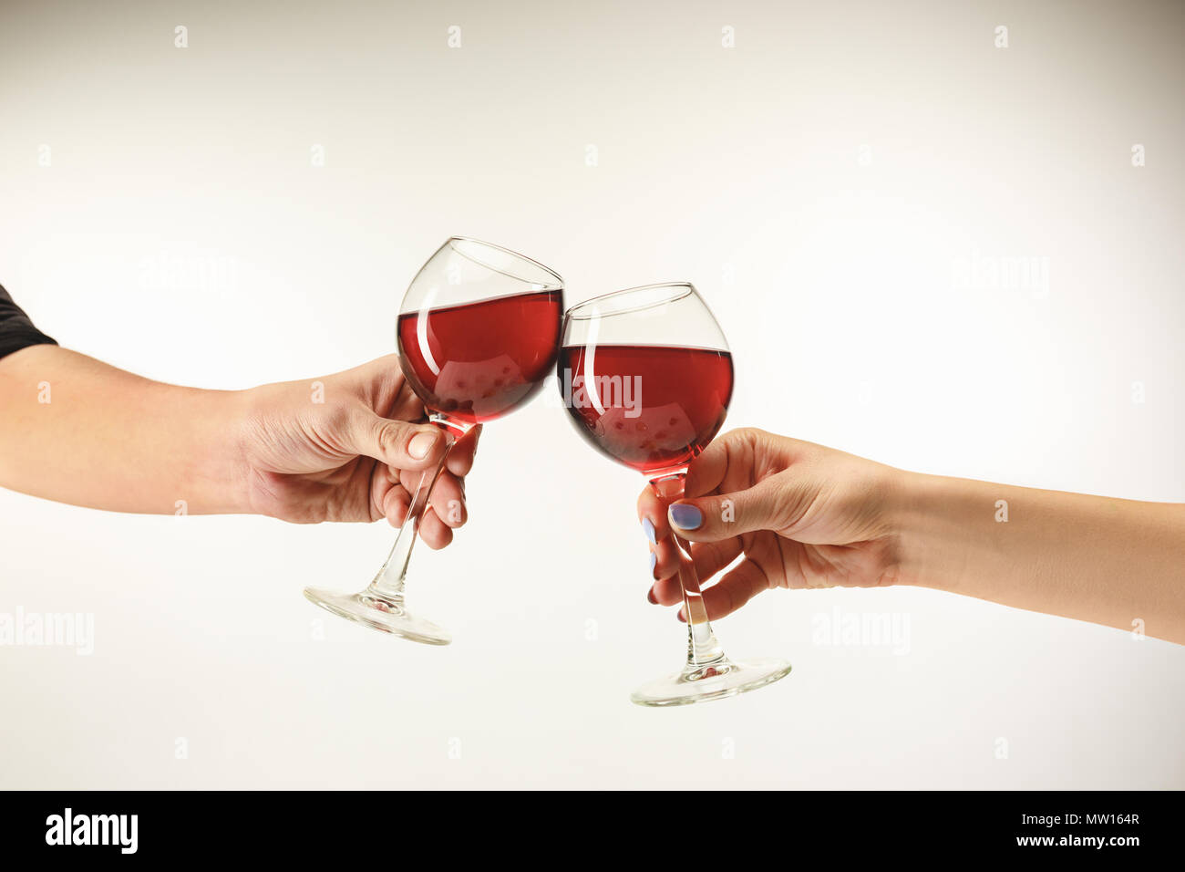 Hands with glasses of red wine, isolated on white Stock Photo - Alamy