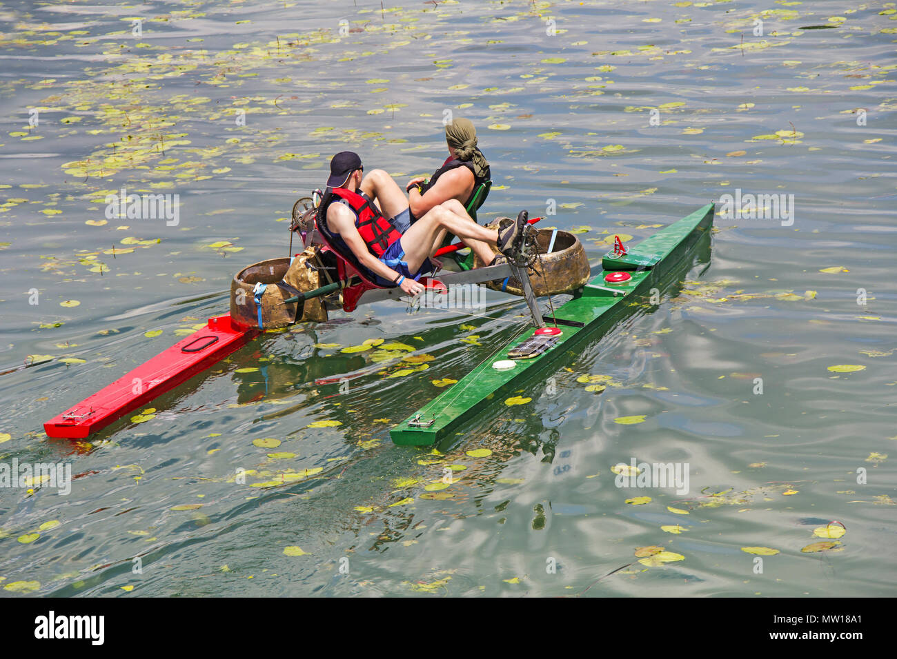 Two man ride with floating pedal bicycle boats across the lake Stock ...
