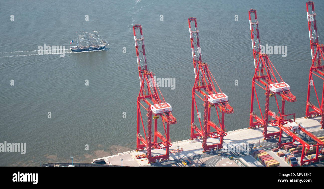 Aerial photo of tall ships passing Port of Liverpool tall red cranes ...
