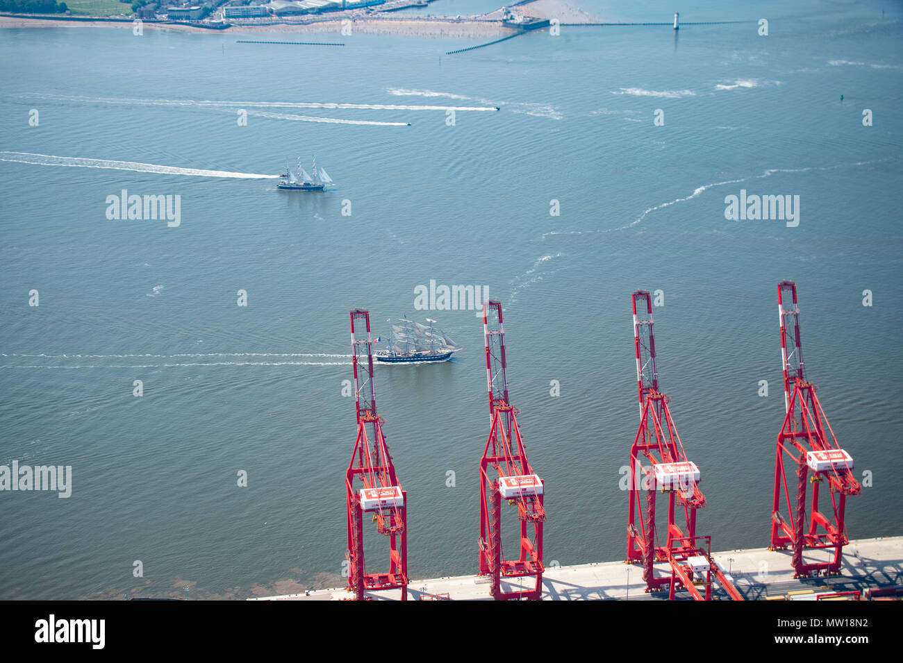 Aerial photo of tall ships passing Port of Liverpool tall red cranes ...