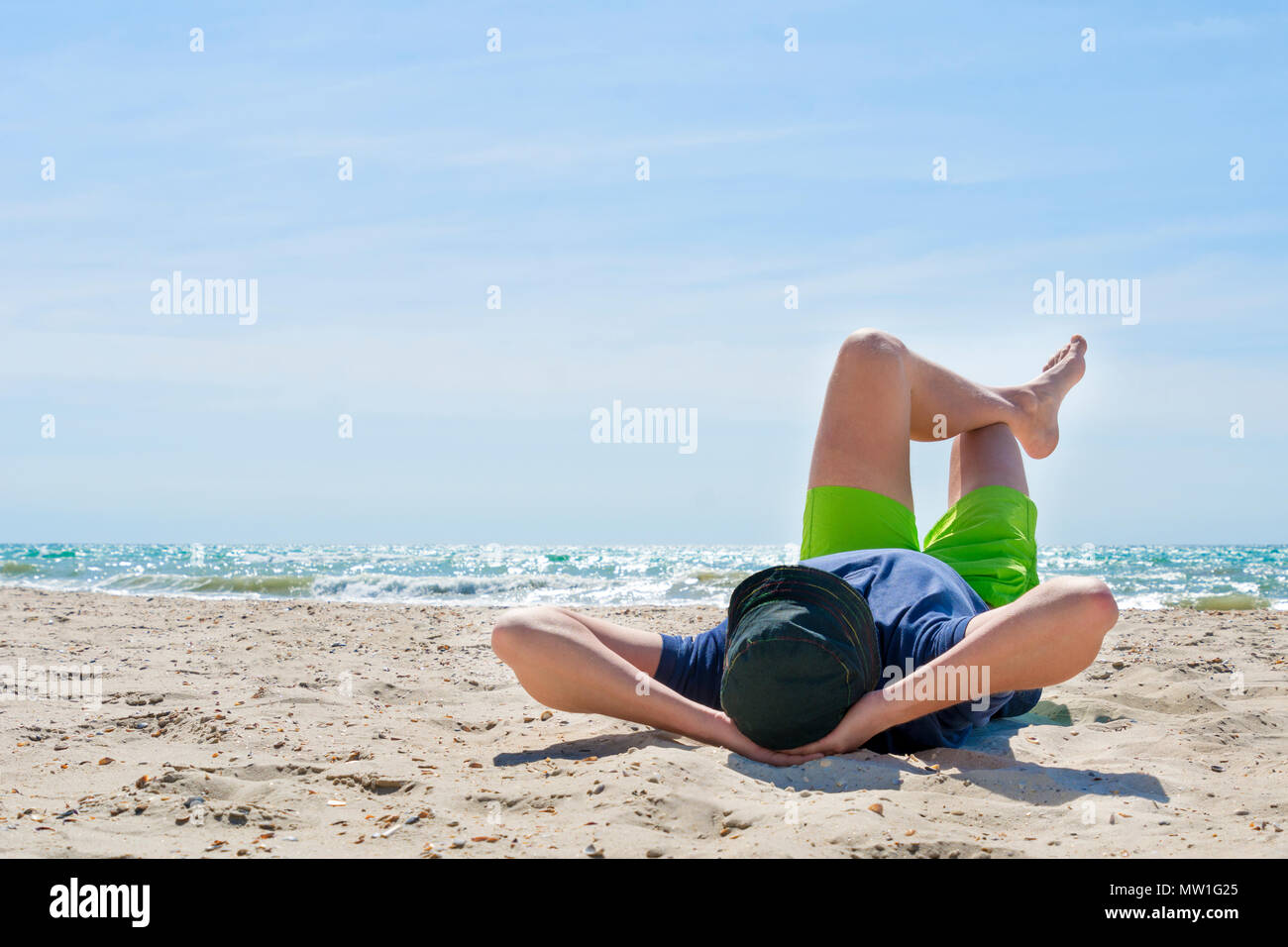 man laying on his back on beach Stock Photo - Alamy