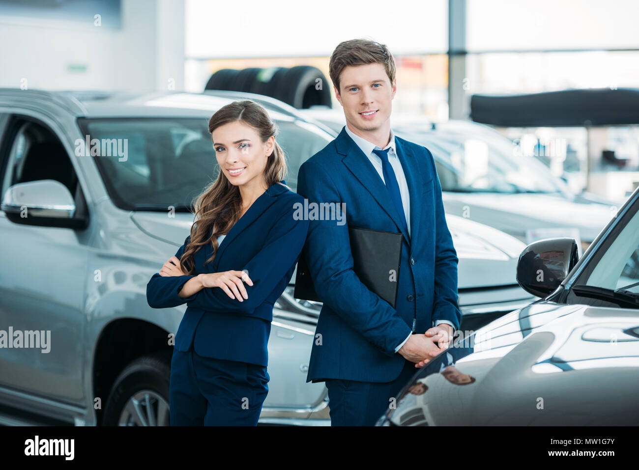 Salesman posing car showroom hi-res stock photography and images - Alamy