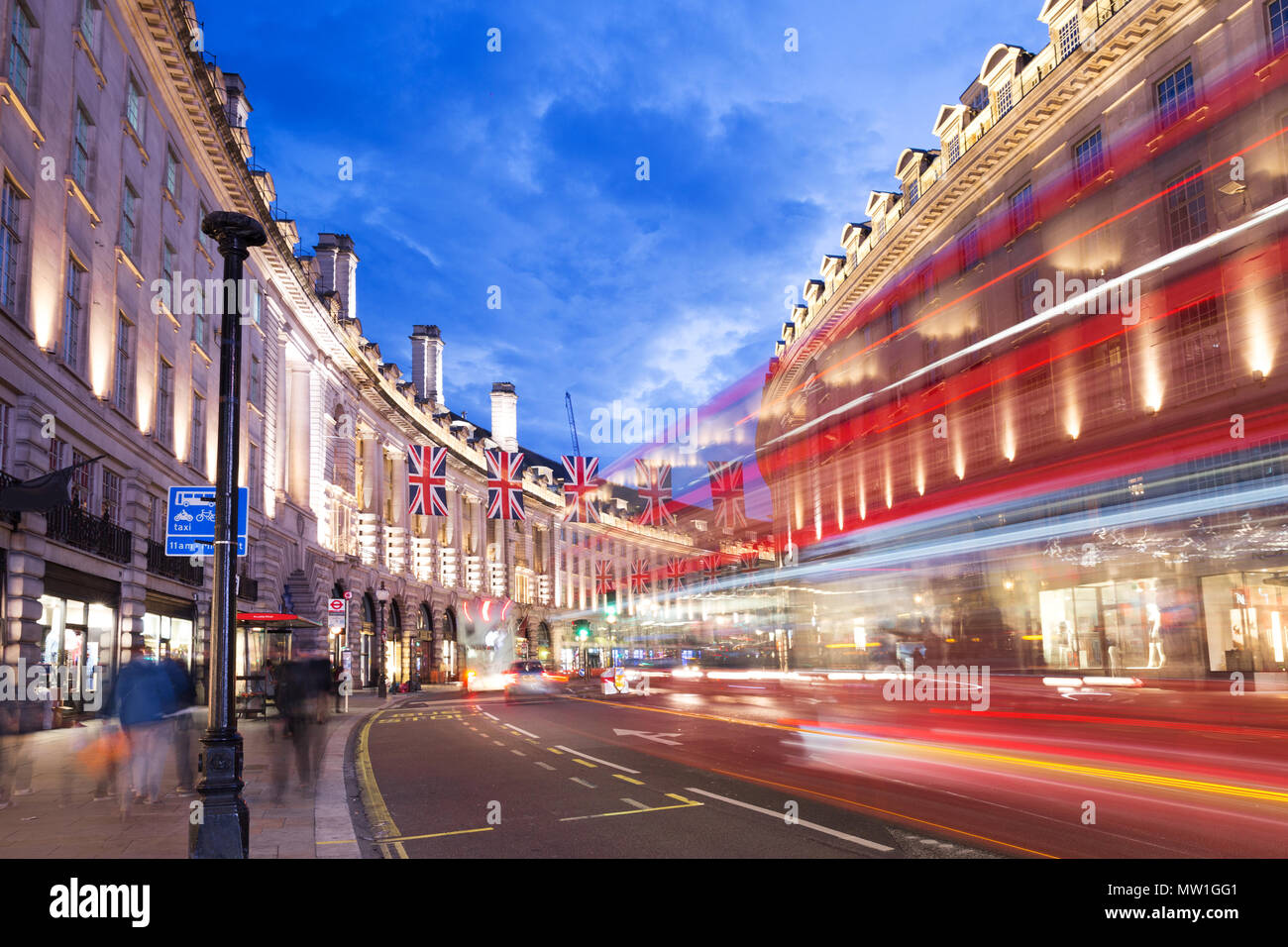Popular tourist Regent street with flags union jack in night lights ...