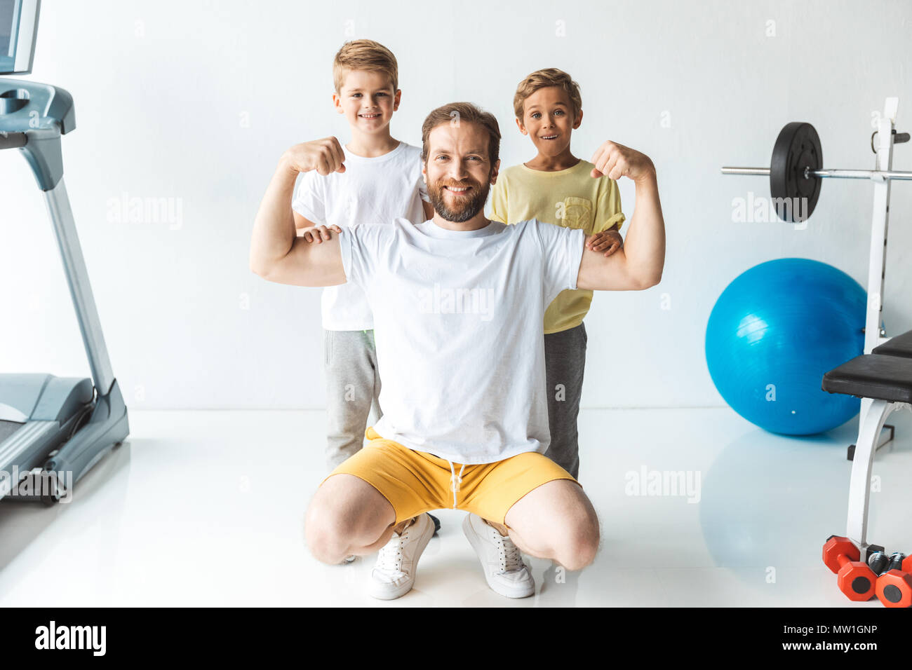 happy sportive family smiling at camera in gym Stock Photo - Alamy
