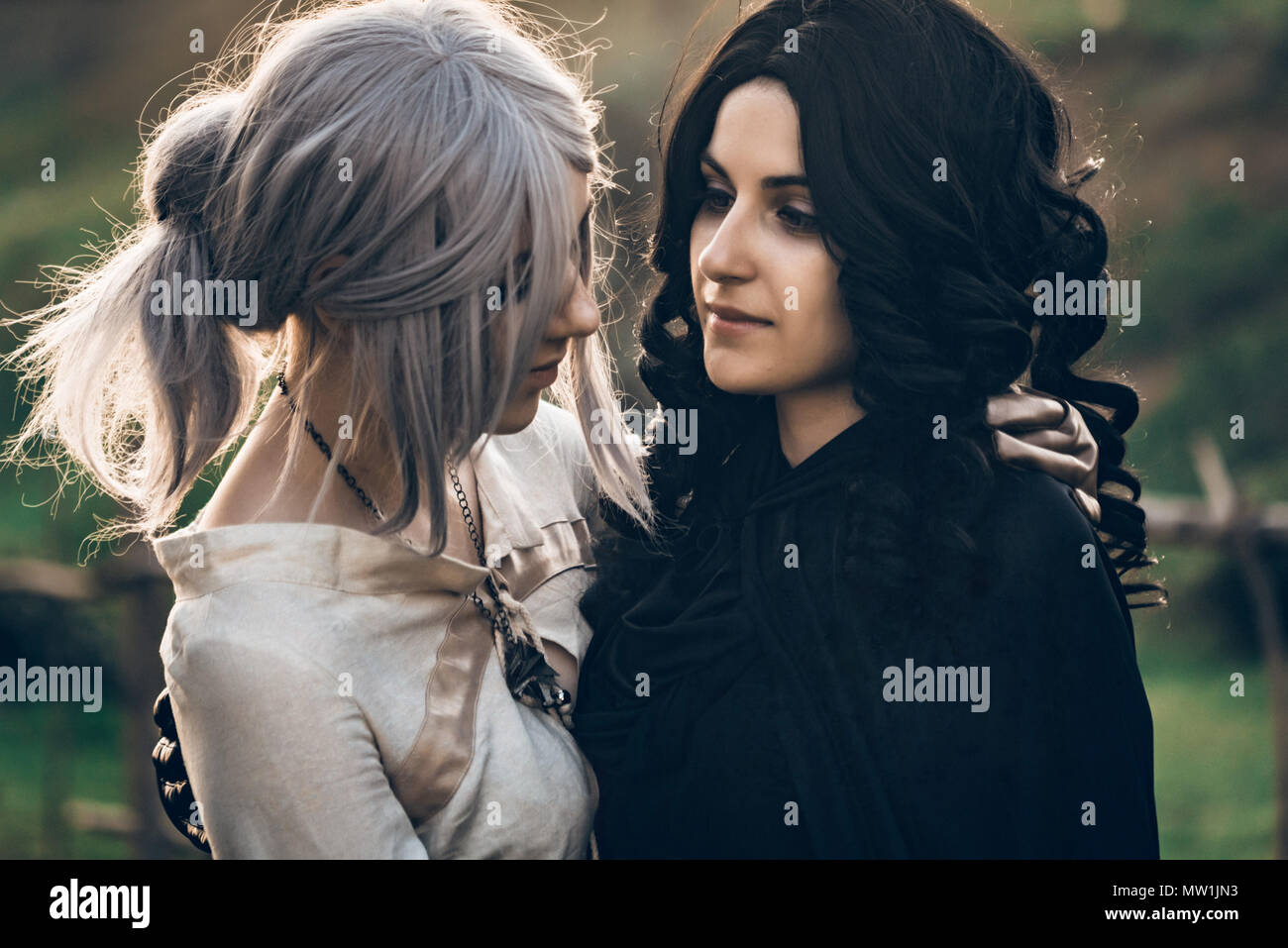 Fantasy cosplay two beautiful girls hug in nature Stock Photo - Alamy